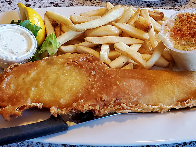 Fish and chips with a golden batter so crisp it practically sings when your fork breaks through to the flaky white fish beneath.
