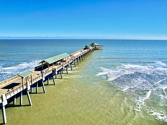 The Folly Beach Pier stretches toward the horizon like a runway to paradise. From this vantage point, everyday worries seem as distant as the skyline.