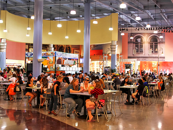 The bustling food court serves as both refueling station and social hub, where shoppers compare conquests over quick bites.
