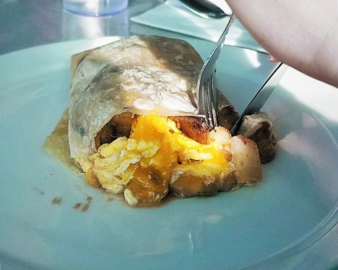 The breakfast burrito: nature's most perfect food delivery system. Peek inside to discover the treasure of eggs, potatoes, and morning joy.