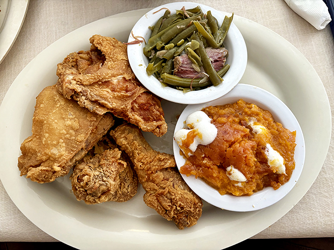 Fried chicken with that perfect golden crust sitting alongside green beans and sweet potato souffl&eacute;&mdash;the holy trinity of Southern comfort.