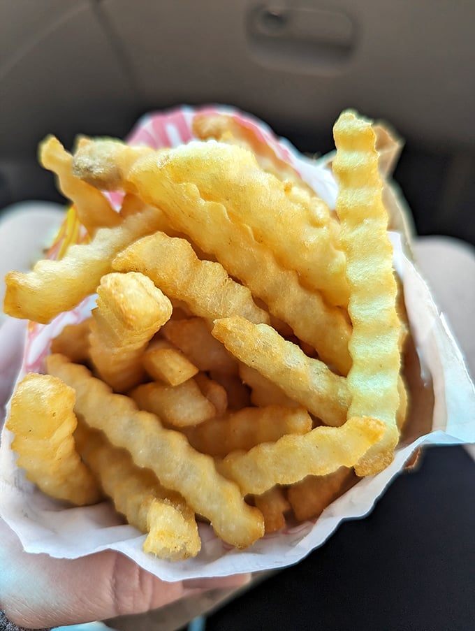 These aren't just fries &ndash; they're golden, crispy vehicles for Kitty's famous hot sauce. Perfection in a paper boat.