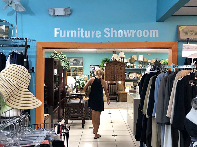 The furniture showroom entrance promises possibilities limited only by your imagination and trunk space. That straw hat standing guard has seen some serious bargain hunting.