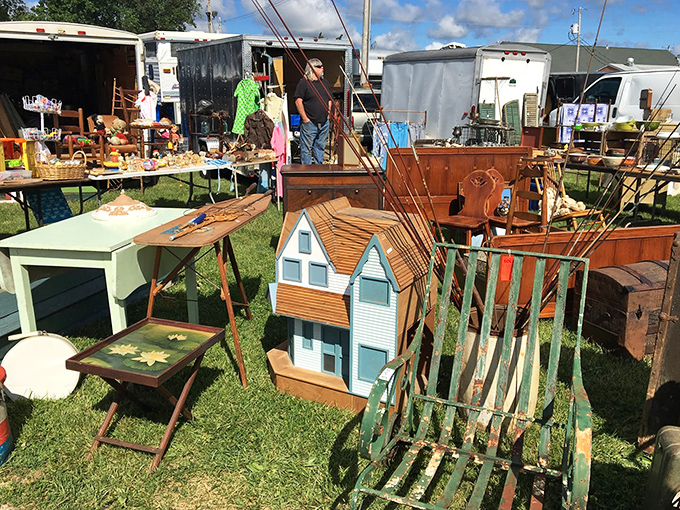 Honey, I shrunk the house! This miniature dollhouse sits among vintage furniture and garden tools, proving good design comes in all sizes.