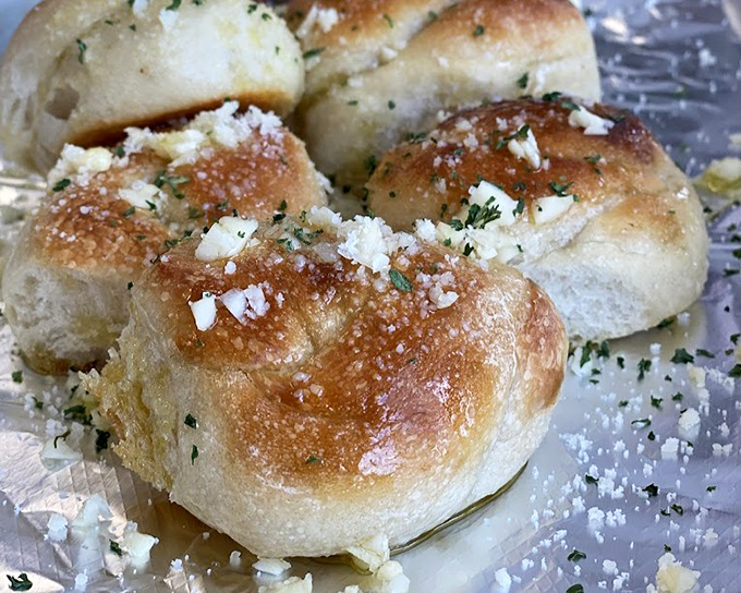 These garlic knots aren't just side dishes; they're little pillows of garlicky heaven that could easily upstage the main event. 