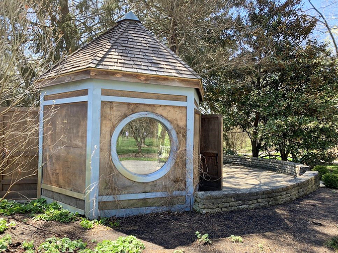 This circular window gazebo offers framed views of seasonal splendor. Step inside for a moment of zen or the perfect Instagram opportunity.