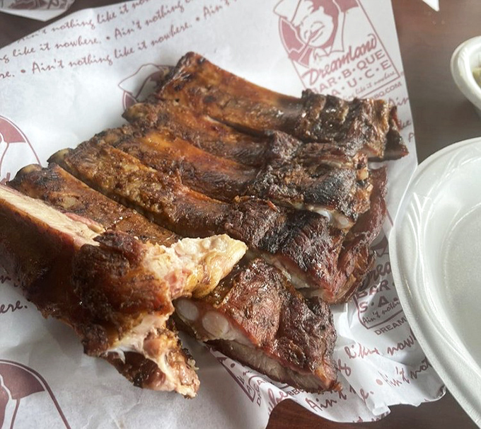 Ribs with the perfect smoke ring and bark that BBQ dreams are made of. The slightly pulled-back meat reveals the tender-not-falling-off balance that true pit masters achieve.