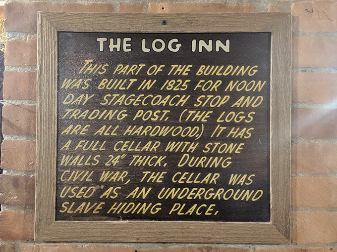 A historical marker revealing The Log Inn's 1825 origins and its role in the Underground Railroad. Dining with a side of American history.
