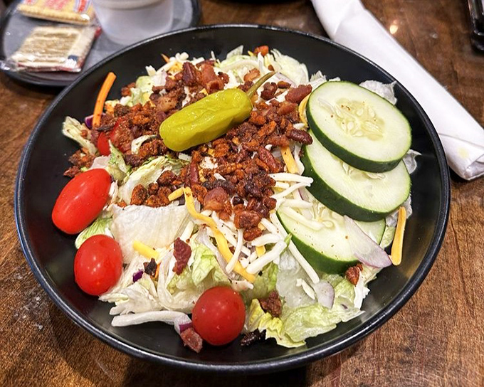A salad that doesn't apologize for being at a barbecue joint. Those bacon bits aren't just toppings&mdash;they're tiny ambassadors from the meat department.