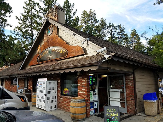 The Village Market, where "running to the store" means encountering more pine-scented air than parking lot exhaust. That barrel out front isn't just decoration.
