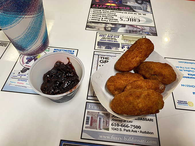 Crispy jalapeño poppers with a side of BBQ sauce—proof that Lou's knows the importance of proper snacking architecture.