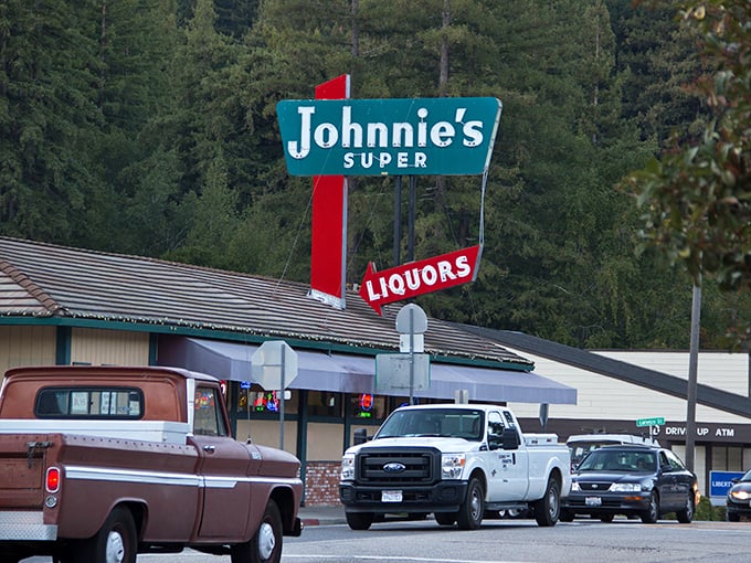 Johnnie's Super sign stands as a mid-century modern beacon among ancient trees, like finding your cool uncle at a family reunion.