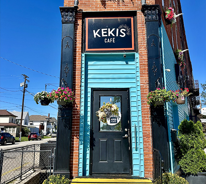 Kekis Caf&eacute;'s charming corner entrance, adorned with hanging flowers, beckons passersby to step into this cozy brick building for a neighborly cup of comfort.
