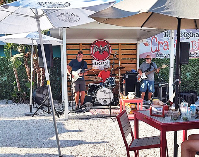 Live music under beach umbrellas creates the soundtrack to your seafood feast &ndash; because grouper sandwiches always taste better with a side of island tunes.