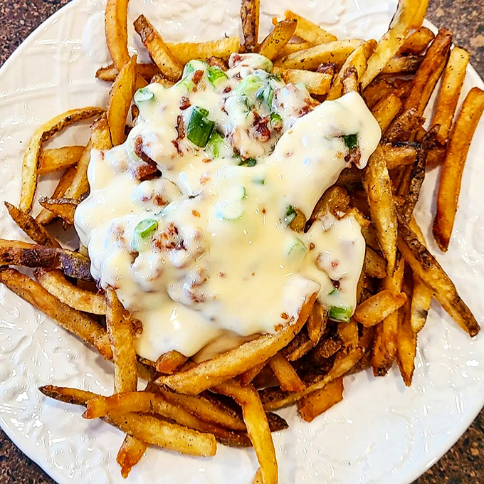 Loaded fries that render conversation impossible except for occasional mumbles of "Oh my god" between blissful, cheese-covered bites.