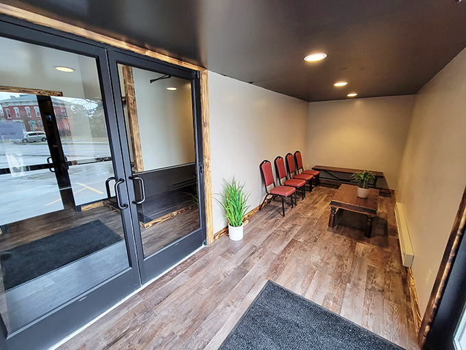 The entryway sets the tone: unpretentious, welcoming, and ready for business. That wooden floor has supported countless happy diners on their way to bourbon bliss.