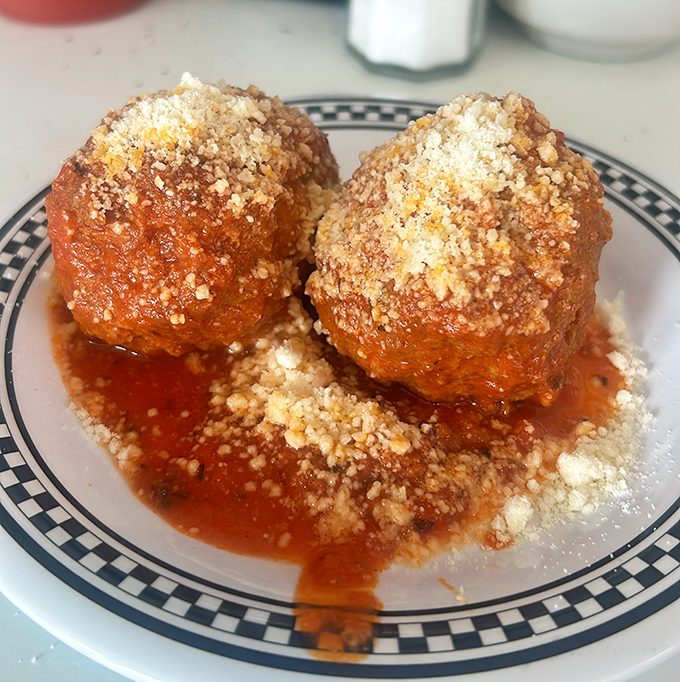 These aren't just meatballs&mdash;they're edible time machines to your Italian grandmother's kitchen, swimming in sauce that simmered for hours.