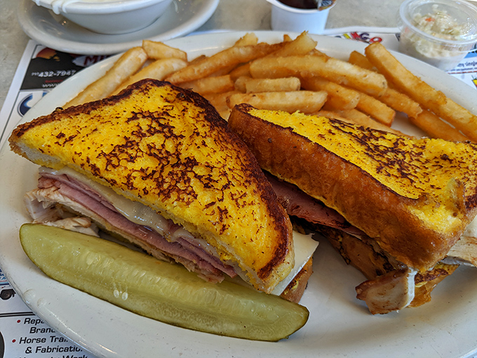 A sandwich stacked higher than your weekend to-do list. Golden-grilled bread holding a treasure of ham and cheese that makes lunch the day's main event.