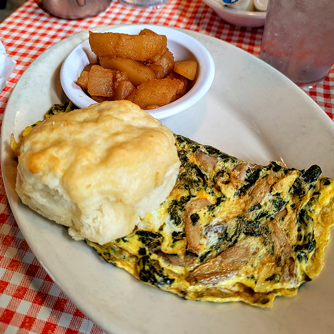 This isn't just an omelet&mdash;it's a fluffy yellow canvas painted with flavors, accompanied by a biscuit that defies gravity.