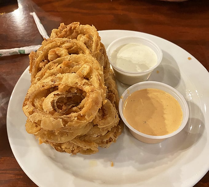 Onion rings stacked like delicious golden halos. These crispy, beer-battered beauties make a compelling case for appetizers as the main event.