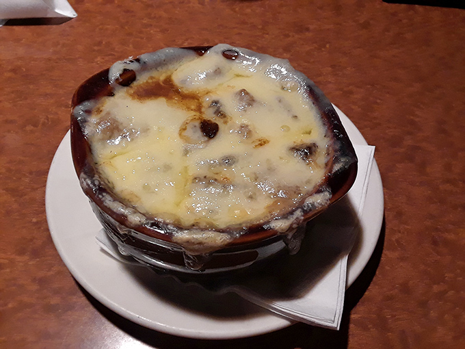 This isn't just onion soup&mdash;it's a bubbling cauldron of comfort topped with a golden cheese cap that stretches dramatically with each spoonful.
