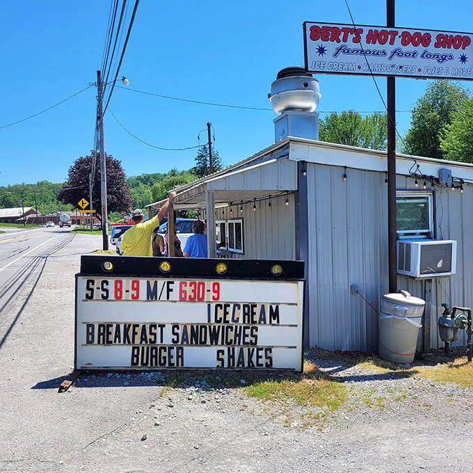 Summer sunshine illuminates this roadside gem. The sign's promise of ice cream and breakfast sandwiches is like poetry to hungry travelers.