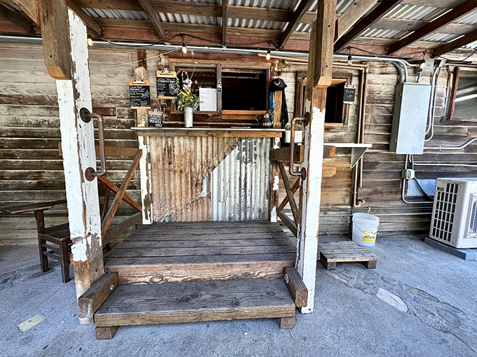 Order windows that feel like discovering a secret speakeasy &ndash; corrugated metal and weathered wood framing culinary treasures within.