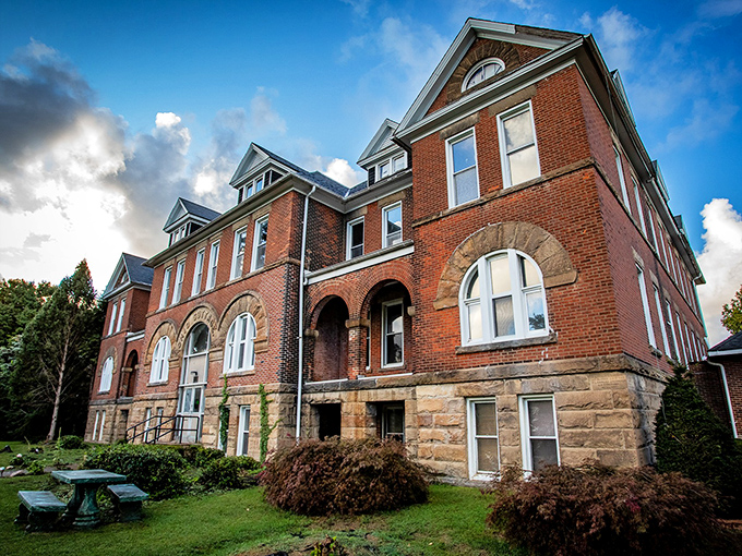 Dramatic clouds frame the Seminary's imposing silhouette. The stone foundation and brick walls have contained laughter, tears, and perhaps a few lingering spirits.