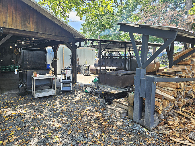 The outdoor pit area&mdash;barbecue's holy ground. Those stacks of wood aren't just fuel; they're the building blocks of flavor architecture.