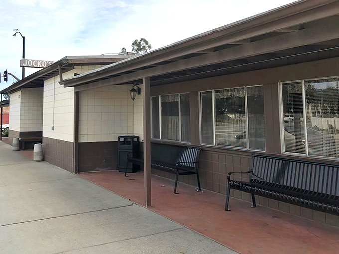 The most honest restaurant entrance in California. No valet, no red carpet—just benches where hungry pilgrims wait their turn for meat nirvana.