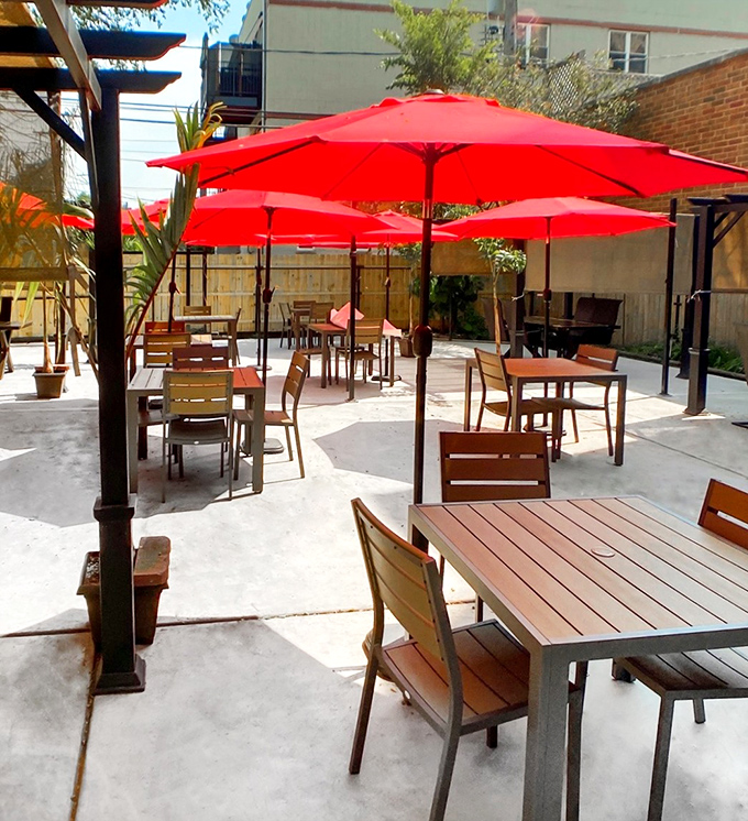 The outdoor patio with bright red umbrellas offers a perfect summer setting for cracking shells and making memories.