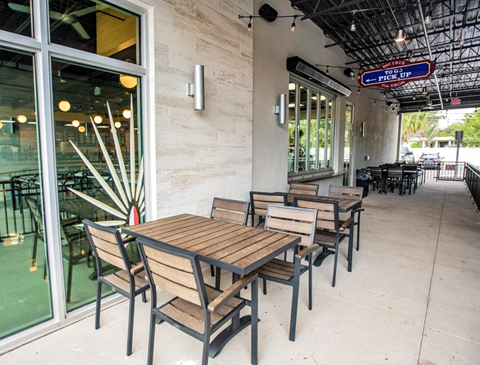 The outdoor patio—where Tampa's sunshine meets Cuban flavors. These tables have witnessed countless coffee dates, business meetings, and "just one more pastry" moments.