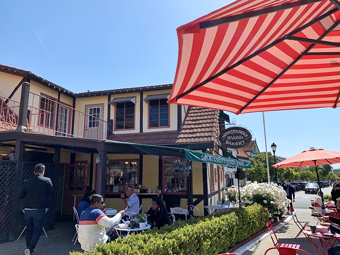 Al fresco dining under cheerful red-striped umbrellas&mdash;where pastry consumption becomes a spectator sport for envious passersby.