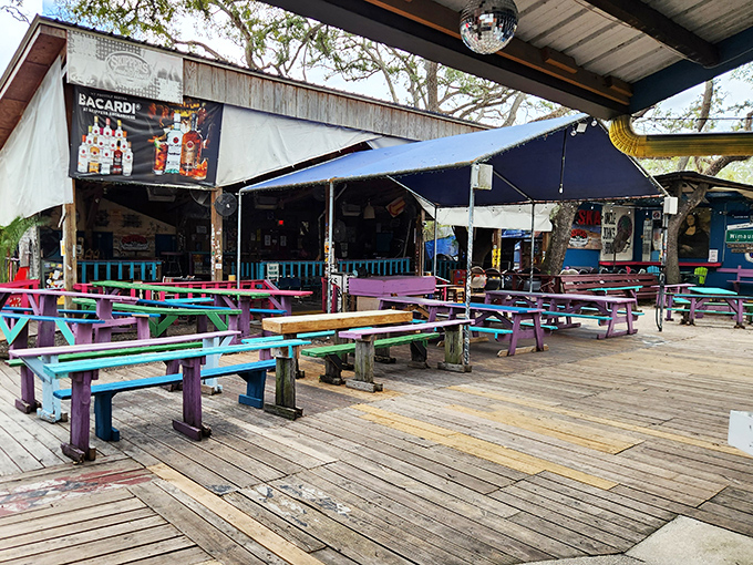 Multicolored picnic tables create an outdoor dining palette as vibrant as the food. Al fresco eating with artistic flair.