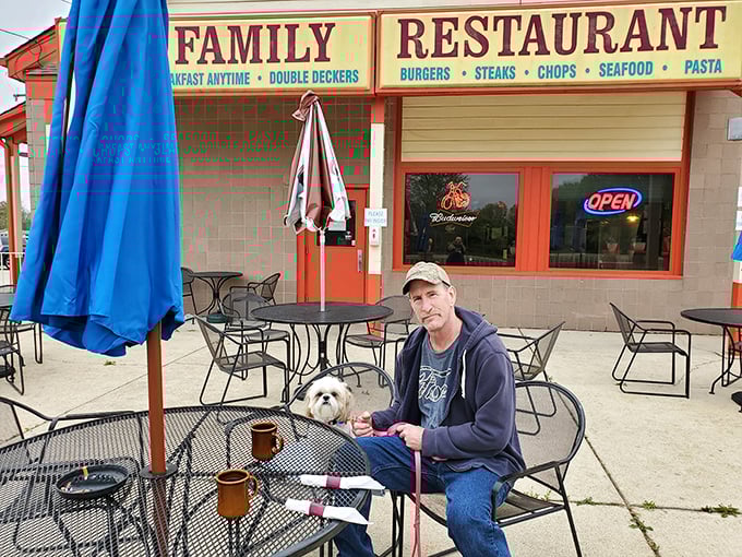 The outdoor patio: where man, best friend, and breakfast unite under Ohio skies. Coffee tastes 30% better when consumed in fresh air.