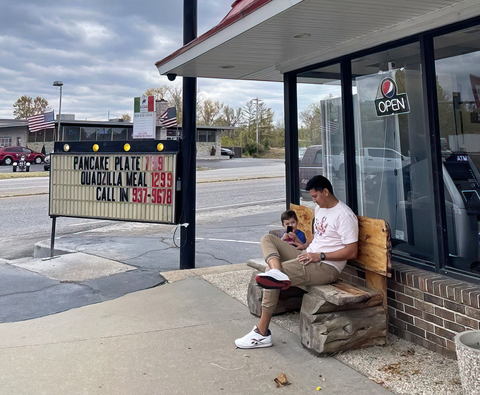 The sidewalk waiting room—where anticipation builds and the aroma of grilling burgers makes even the most patient person check their watch.