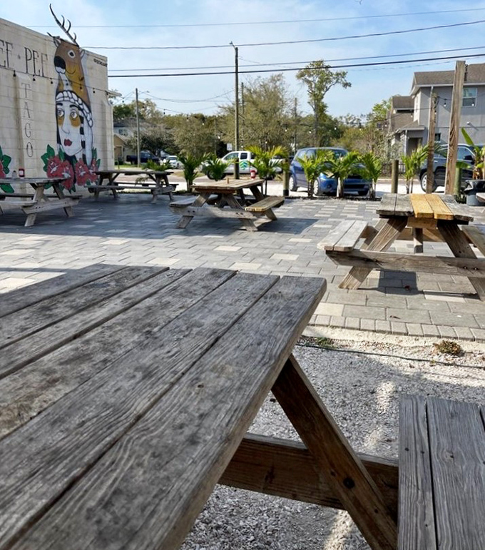 Weathered picnic tables under Florida sun - outdoor dining doesn't get more perfectly casual than this.