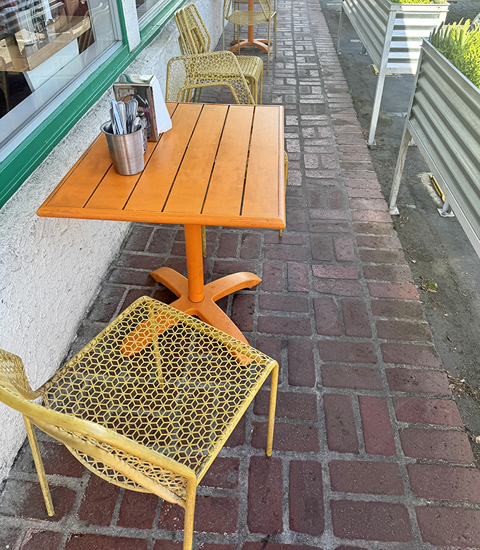Even the outdoor seating maintains that cheerful orange theme, because consistency matters in the diner game.