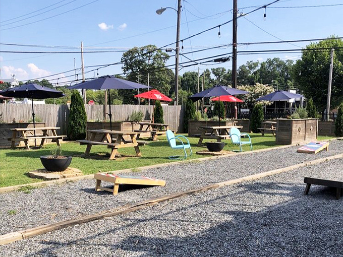The outdoor beer garden – where picnic tables, umbrellas, and cornhole boards create the backyard party you wish you could host at home.