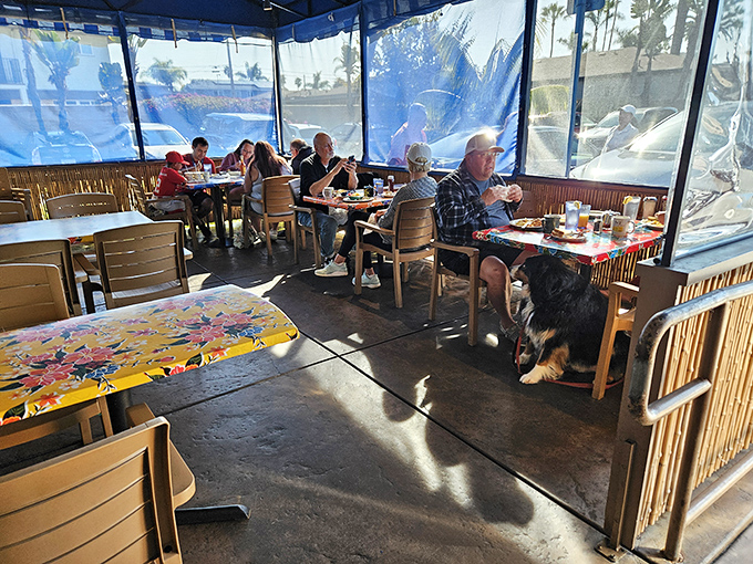 Even dogs know where the good food is. This covered patio offers ocean breezes with your coffee and a front-row seat to Oceanside life.