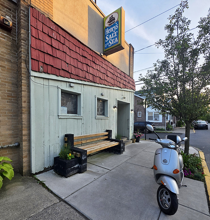 Outside sits a humble bench and a Vespa&mdash;both promising journeys, though only one leads to seafood paradise behind that unassuming door.