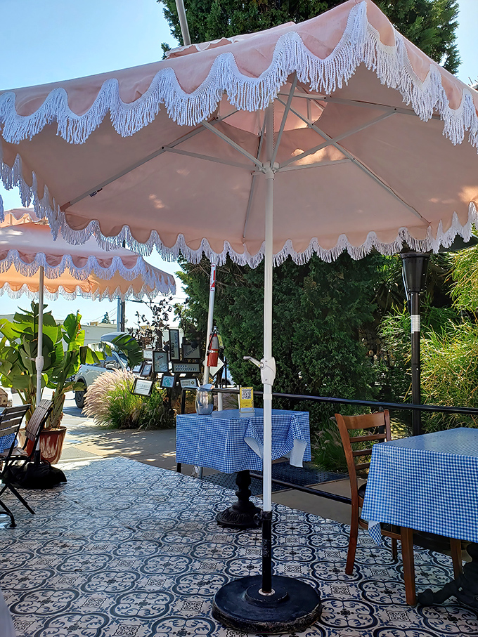 Blue-checkered tablecloths under pink fringed umbrellas&mdash;like dining at your stylish Cuban grandmother's house, if she had excellent taste in patio furniture.
