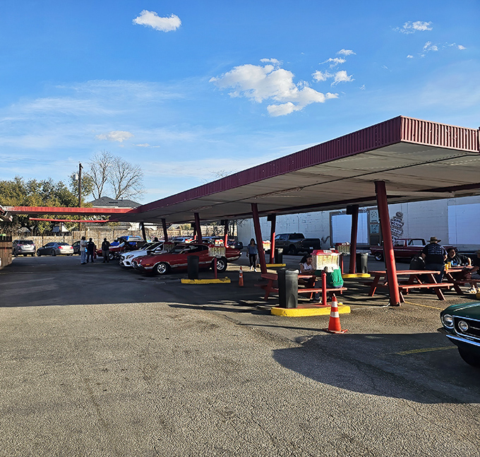 The covered parking area isn't just practical&mdash;it's sacred ground where classic cars and classic meals come together in perfect harmony.