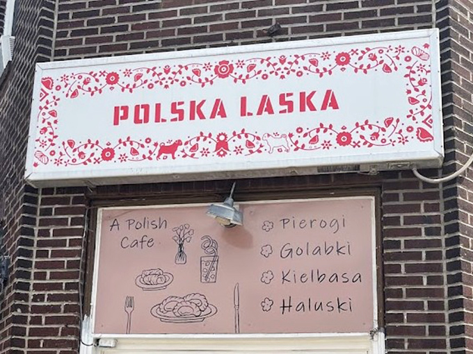 The sign says "Polska Laska" but it might as well read "Abandon diet, all ye who enter here." Folk art borders frame the promise of pierogi perfection.