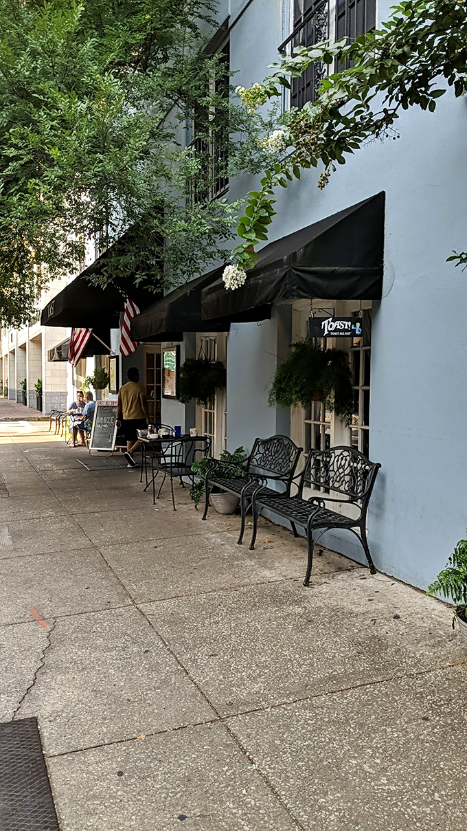 Sidewalk seating where patience is rewarded with tables and passing Charleston becomes free entertainment.