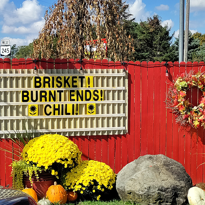 "Brisket! Burnt Ends! Chili!" – the roadside marquee equivalent of poetry. Those yellow mums are just showing off at this point.
