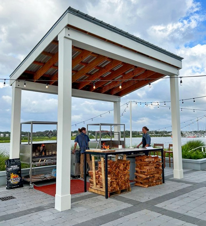 The outdoor grilling station where flames dance and meat transforms into something approaching the divine through ancient techniques.