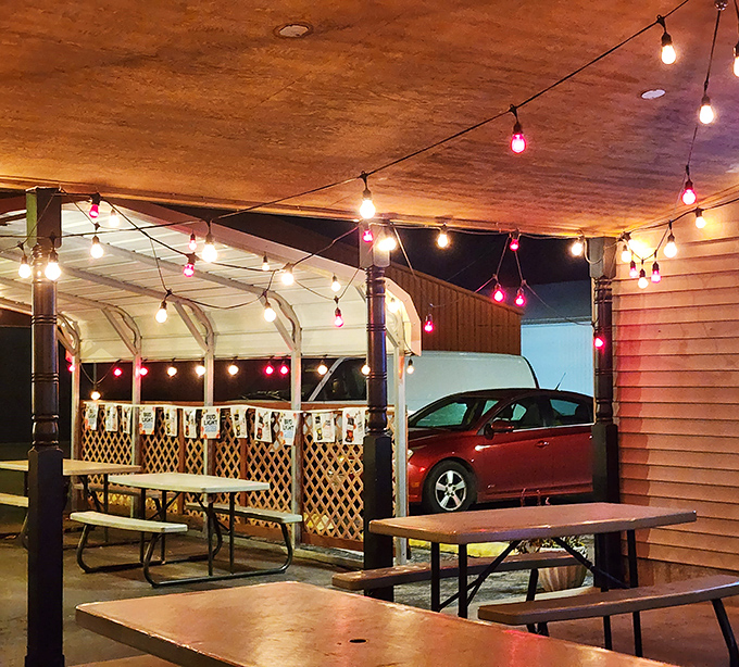 Outdoor seating strung with lights for when your barbecue cravings strike after dark. Simple picnic tables say "focus on the food."