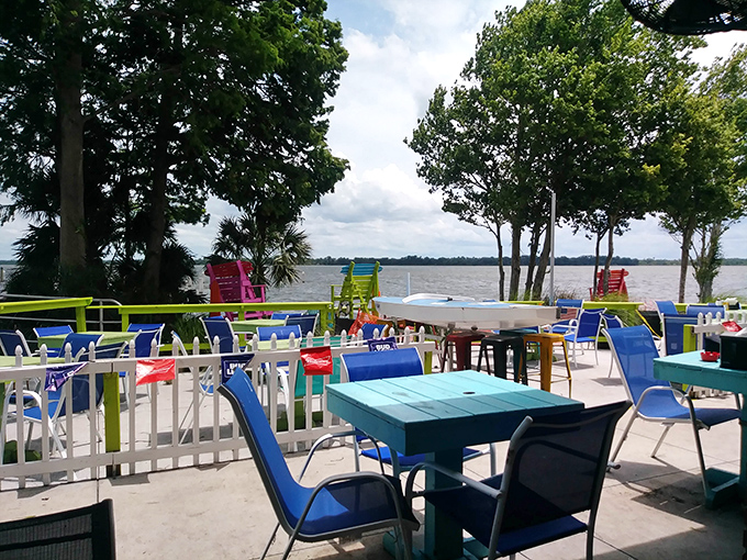 Colorful tables that match the vibrant water view&mdash;because in Florida, even the furniture knows it's supposed to make you smile.