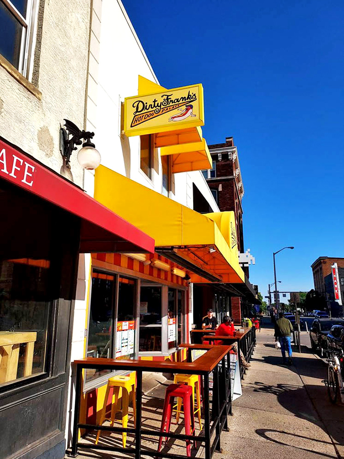Outdoor seating under that signature yellow awning offers prime people-watching with your hot dog&mdash;urban dining at its most honest.